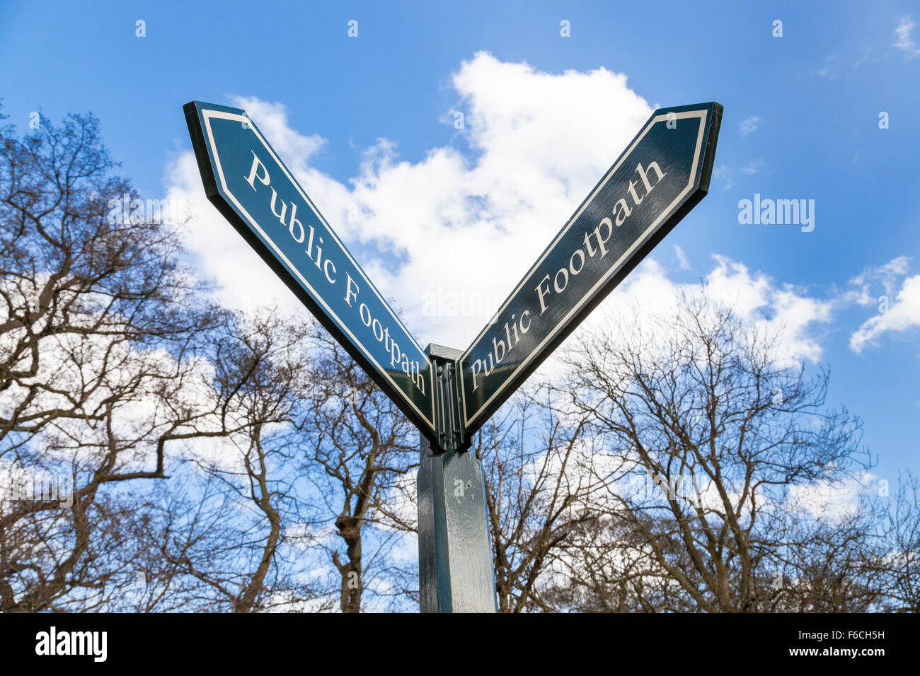 Public footpath signpost with two signs pointing in different ...