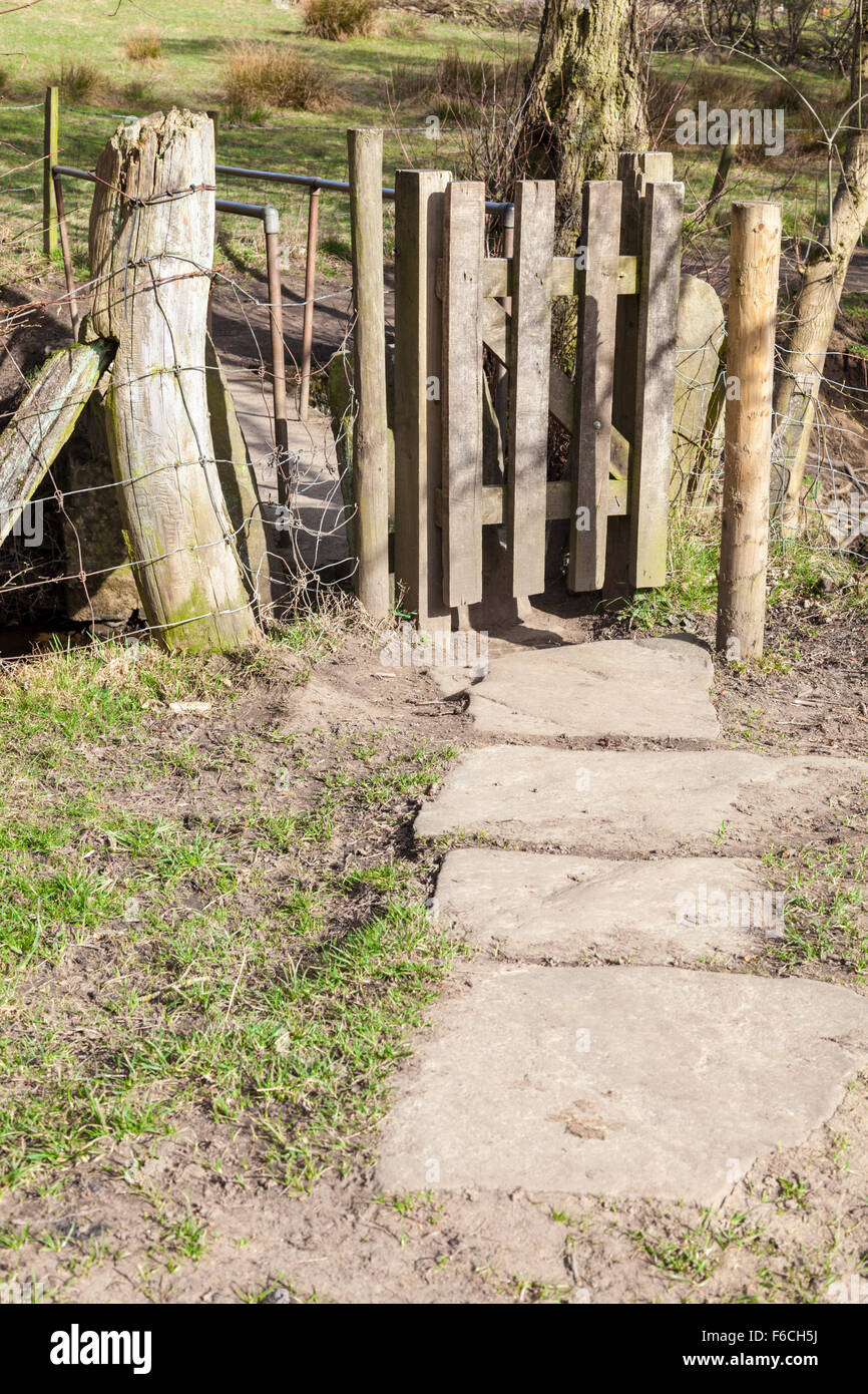 Small wooden gate and a stone paved footpath in Derbyshire, England, UK ...
