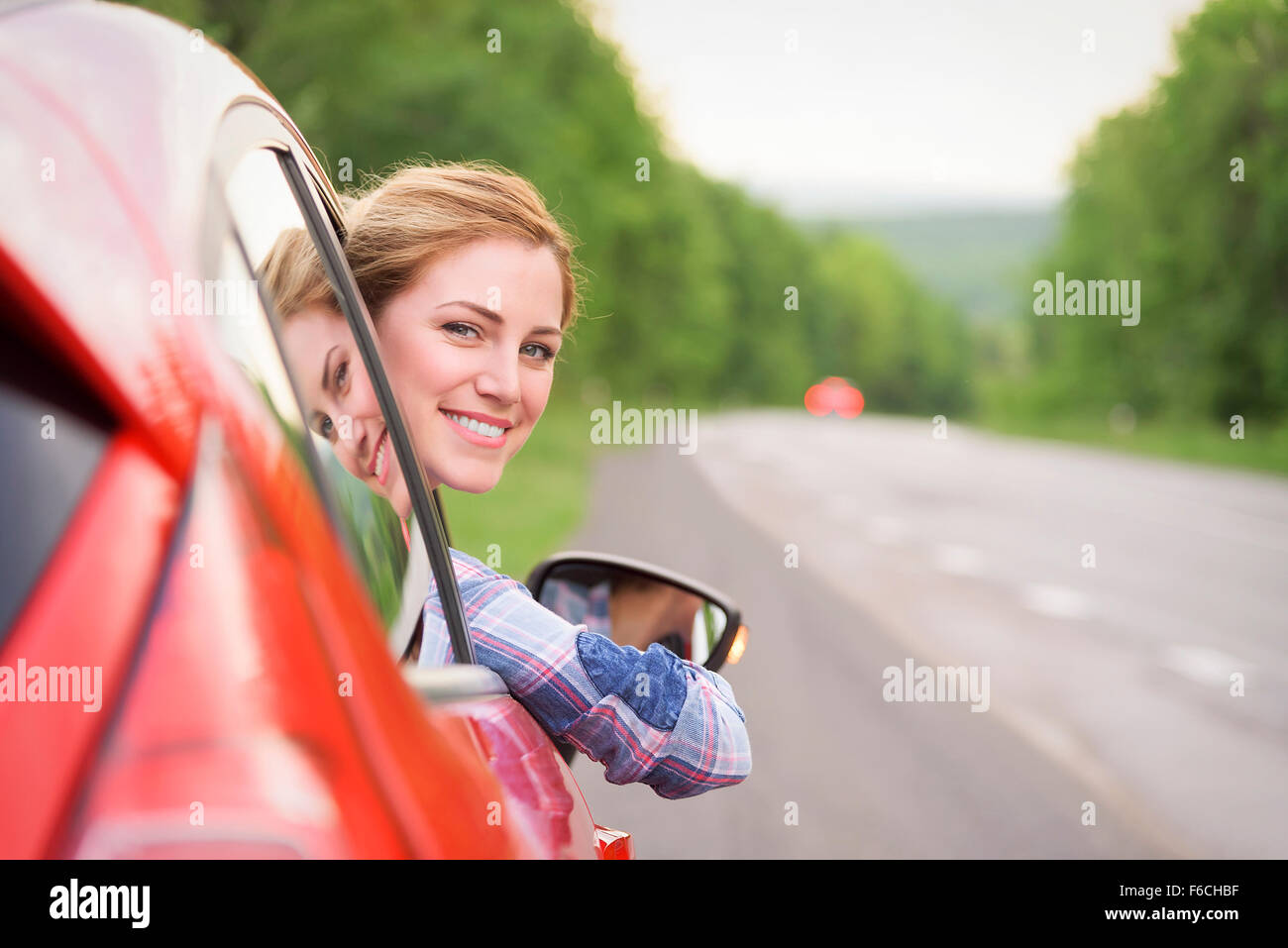 Woman in red car Stock Photo - Alamy