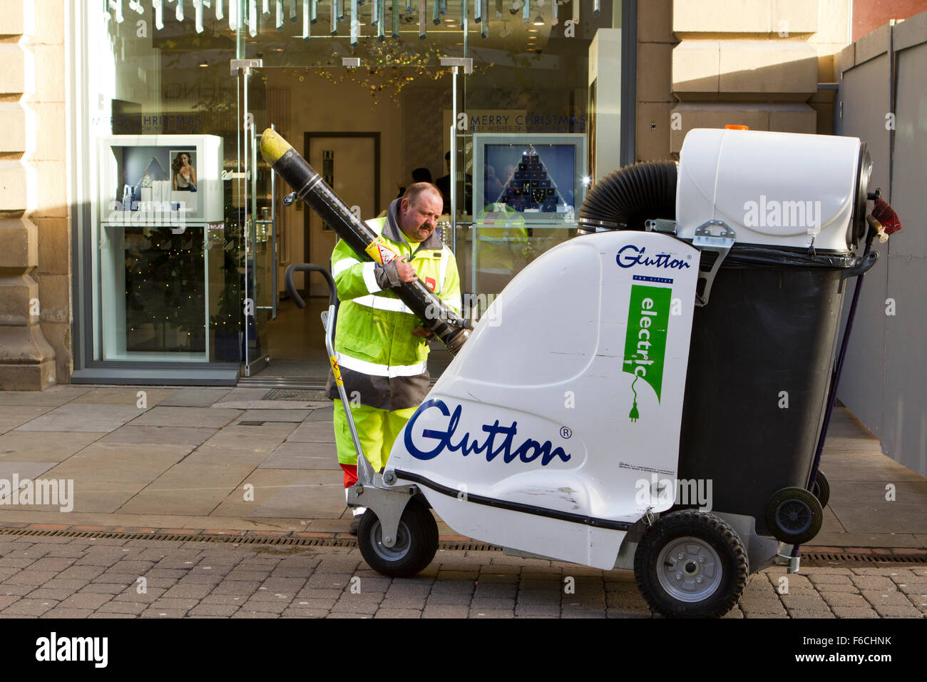 A street cleaner using a Glutton three wheeled street cleaning machine ...
