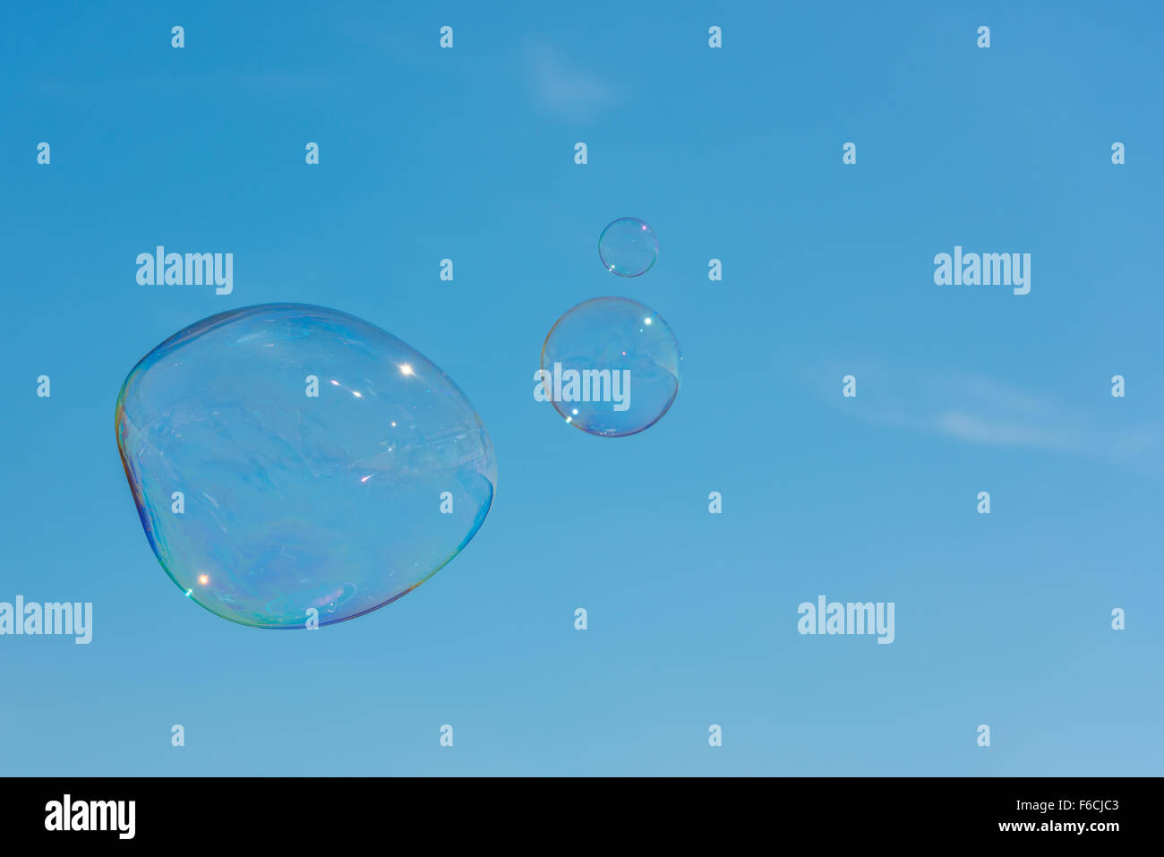Сolorful soap bubbles on a bright blue sky background Stock Photo - Alamy