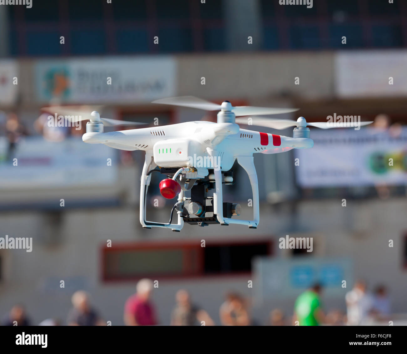 White drone quadcopter in flight with small camcorder Stock Photo - Alamy