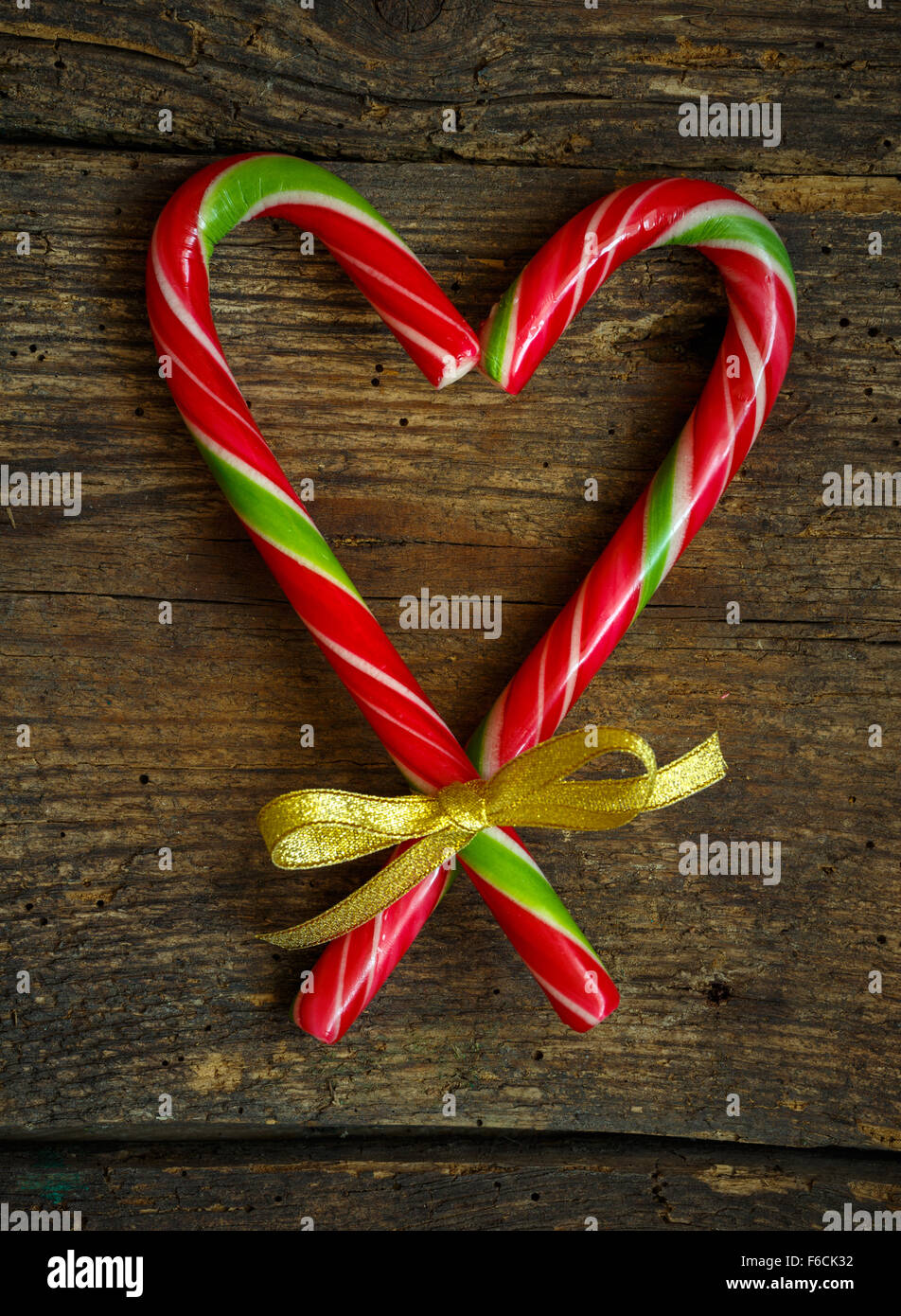 Candy canes in the heart shape on a wooden background Stock Photo - Alamy