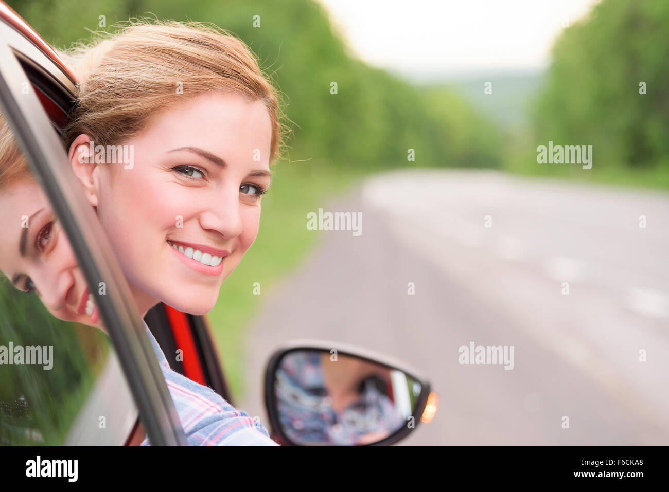 Woman in red car Stock Photo - Alamy