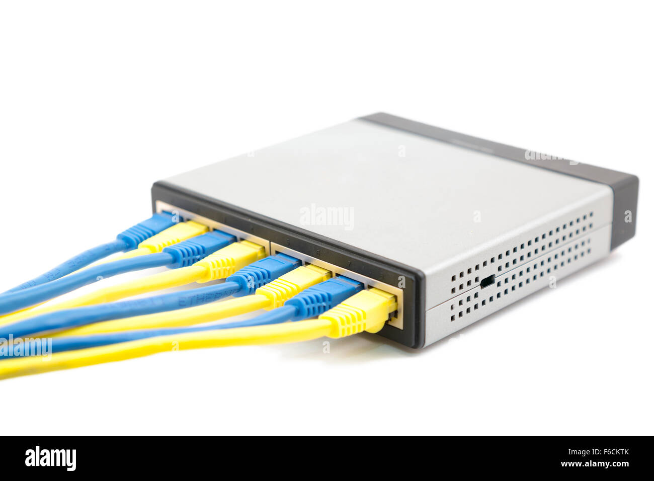 Network switch (router) with blue and yellow cables plugged in Stock ...