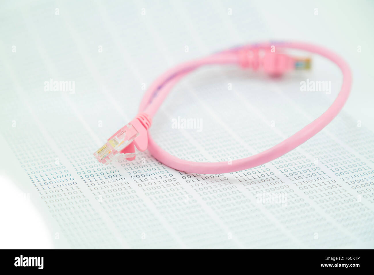 pink network cable against a binary numbers background Stock Photo - Alamy