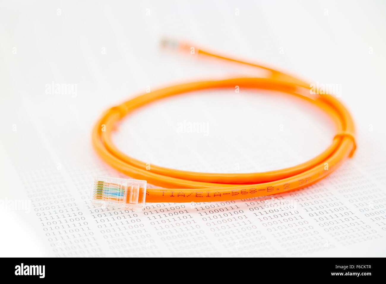 orange network cable against a binary numbers background Stock Photo ...