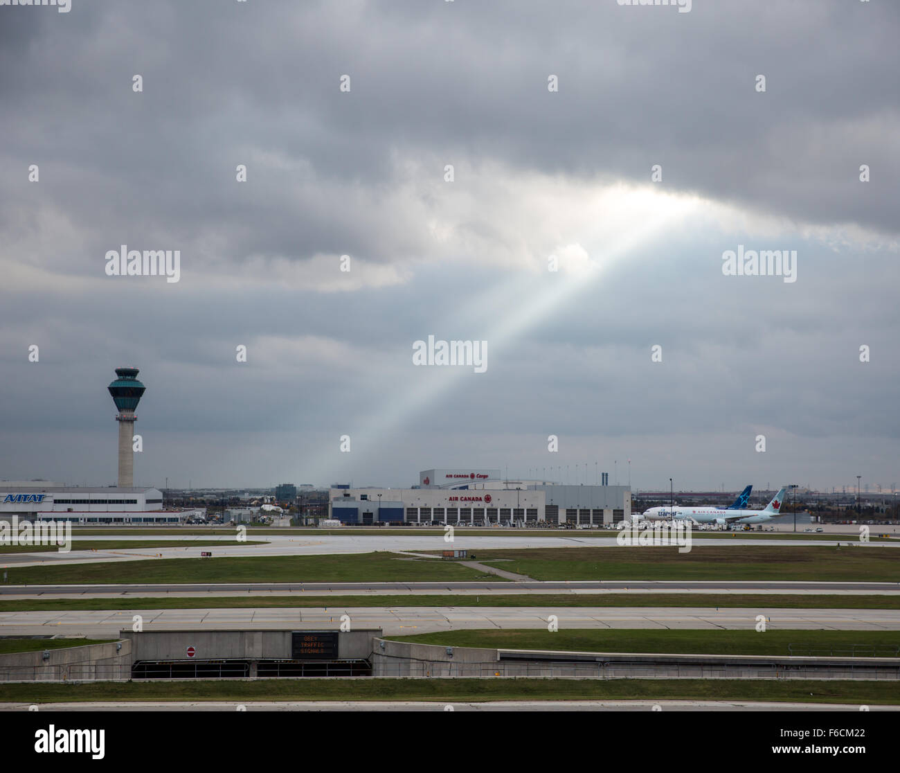 Gatwick Airport runway and air traffic control tower light by a shaft ...