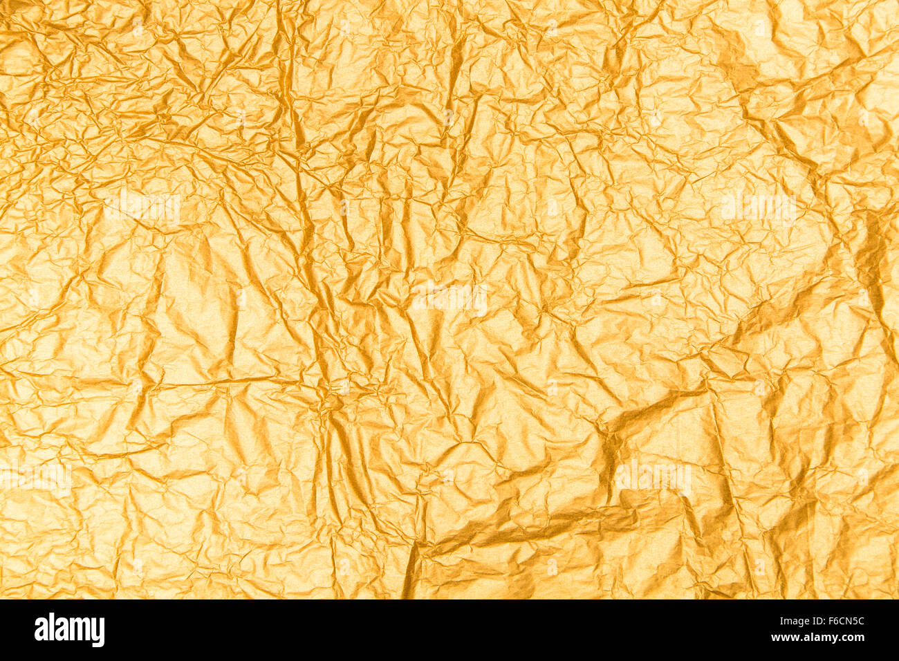 Texture of crumpled packaging gold paper background, creased and folded ...