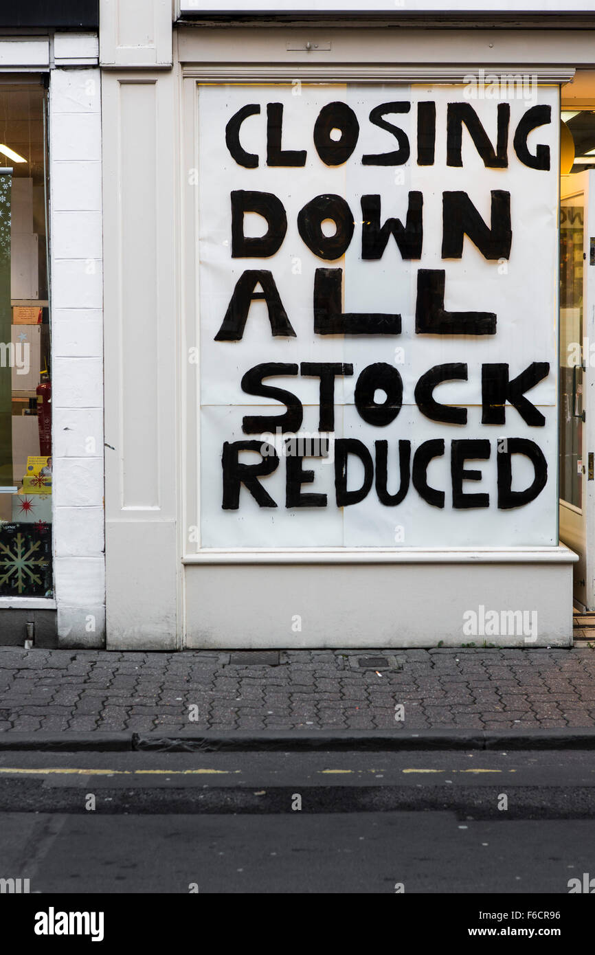 Closing down sign painted on a shop window Stock Photo - Alamy