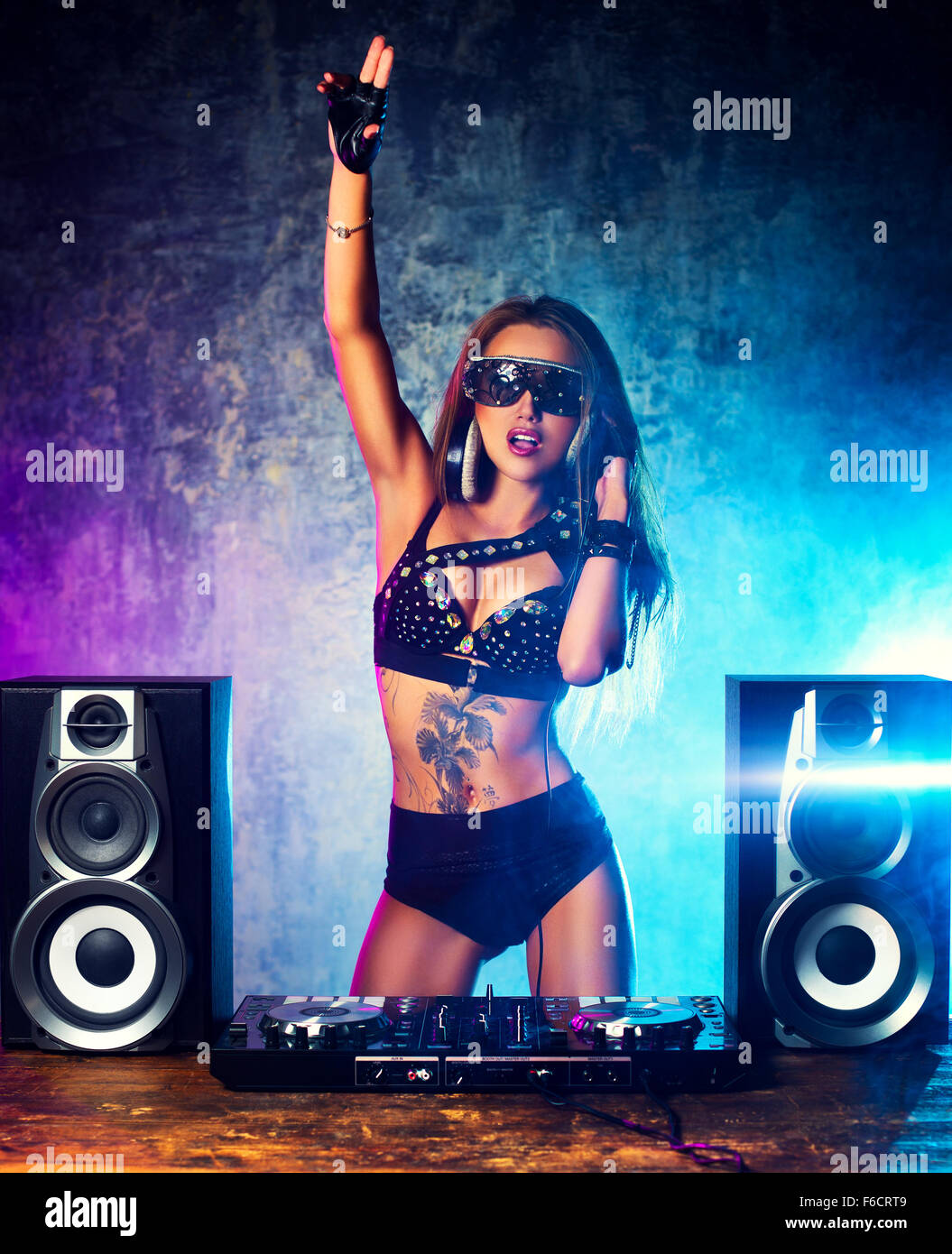 Young Sexy Woman Dj Playing Music Big Loud Speakers Headphones And Dj Mixer On Table Stock