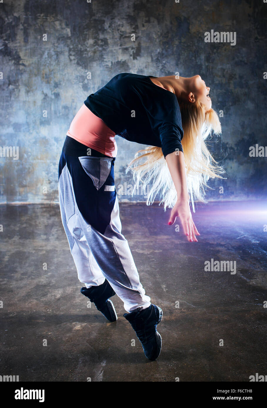 Young woman modern dancer. On stone wall background Stock Photo - Alamy