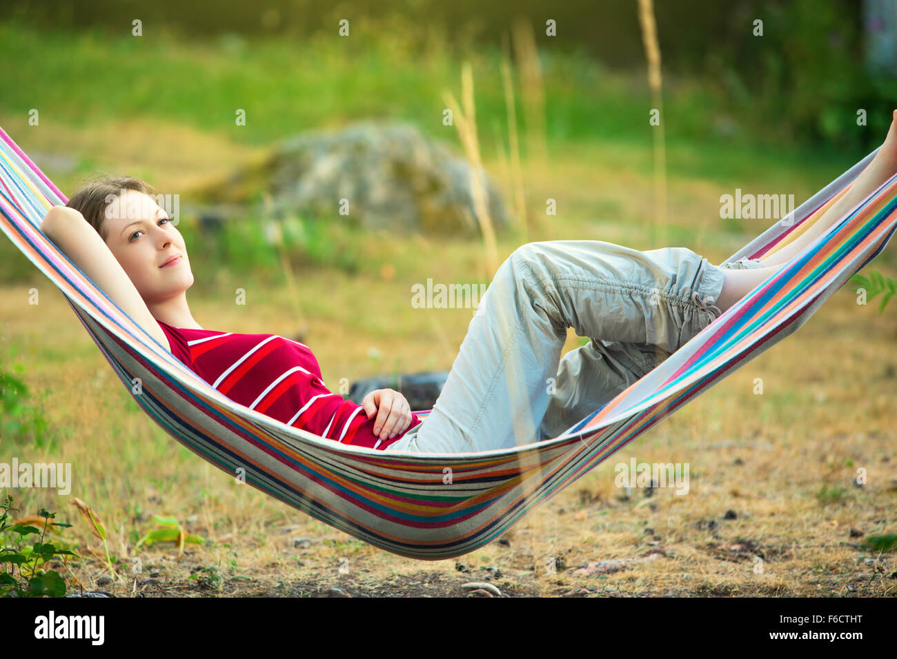 Young woman resting in hammock Stock Photo - Alamy