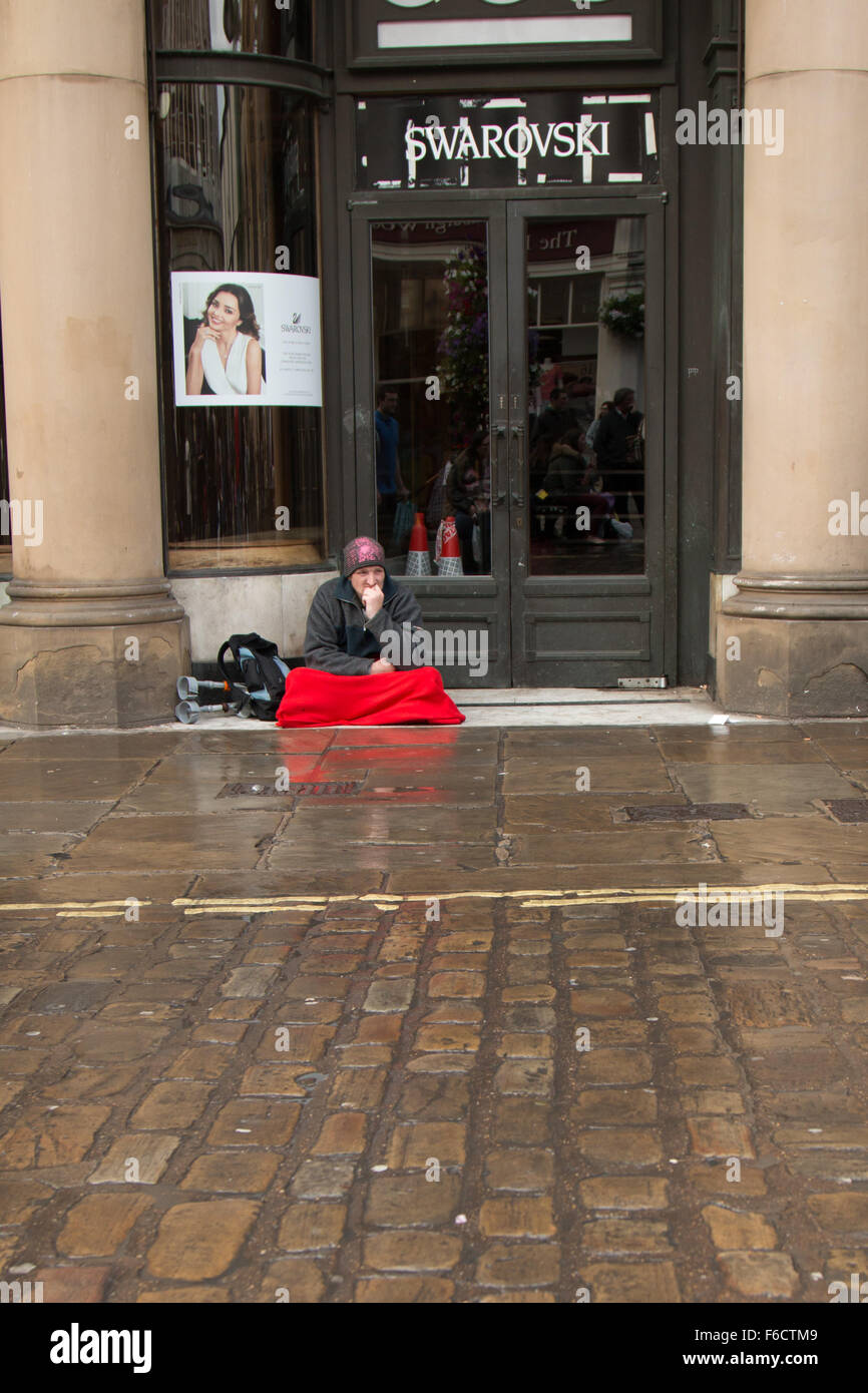 Homeless man sits outside a closed down jewelry shop Stock Photo - Alamy