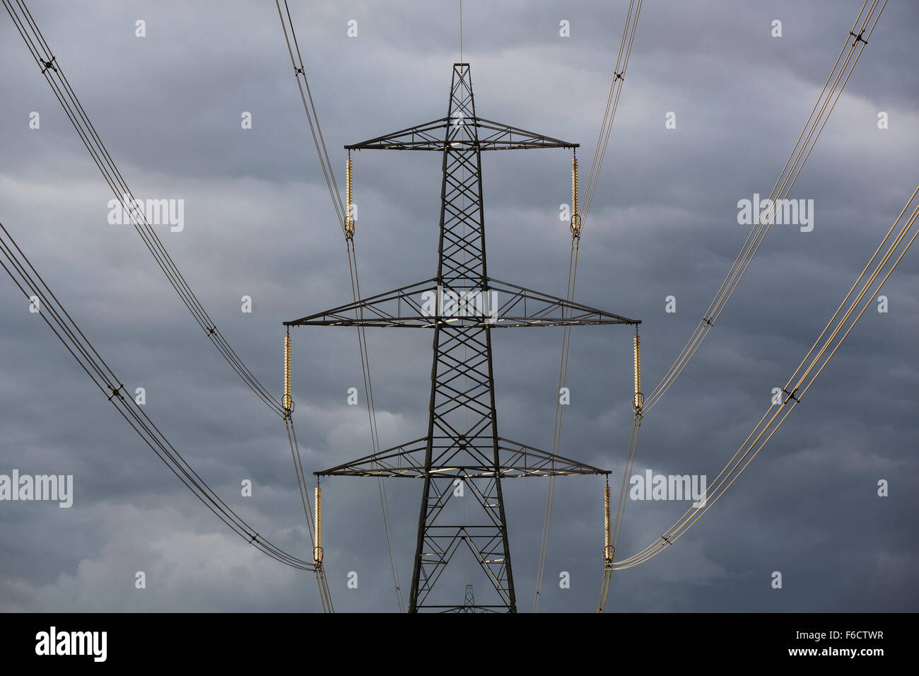 Electrical power lines set against a brooding grey sky Stock Photo - Alamy