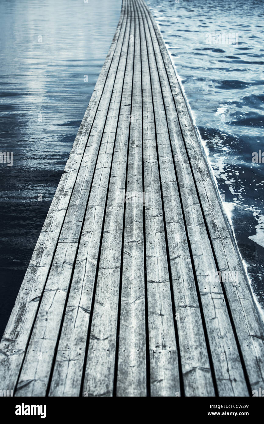 Long floating wooden bridge on water surface Stock Photo - Alamy