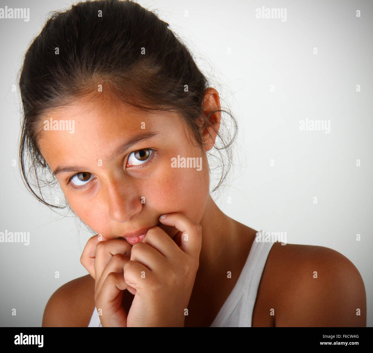Little girl with sad expression on white background Stock Photo - Alamy