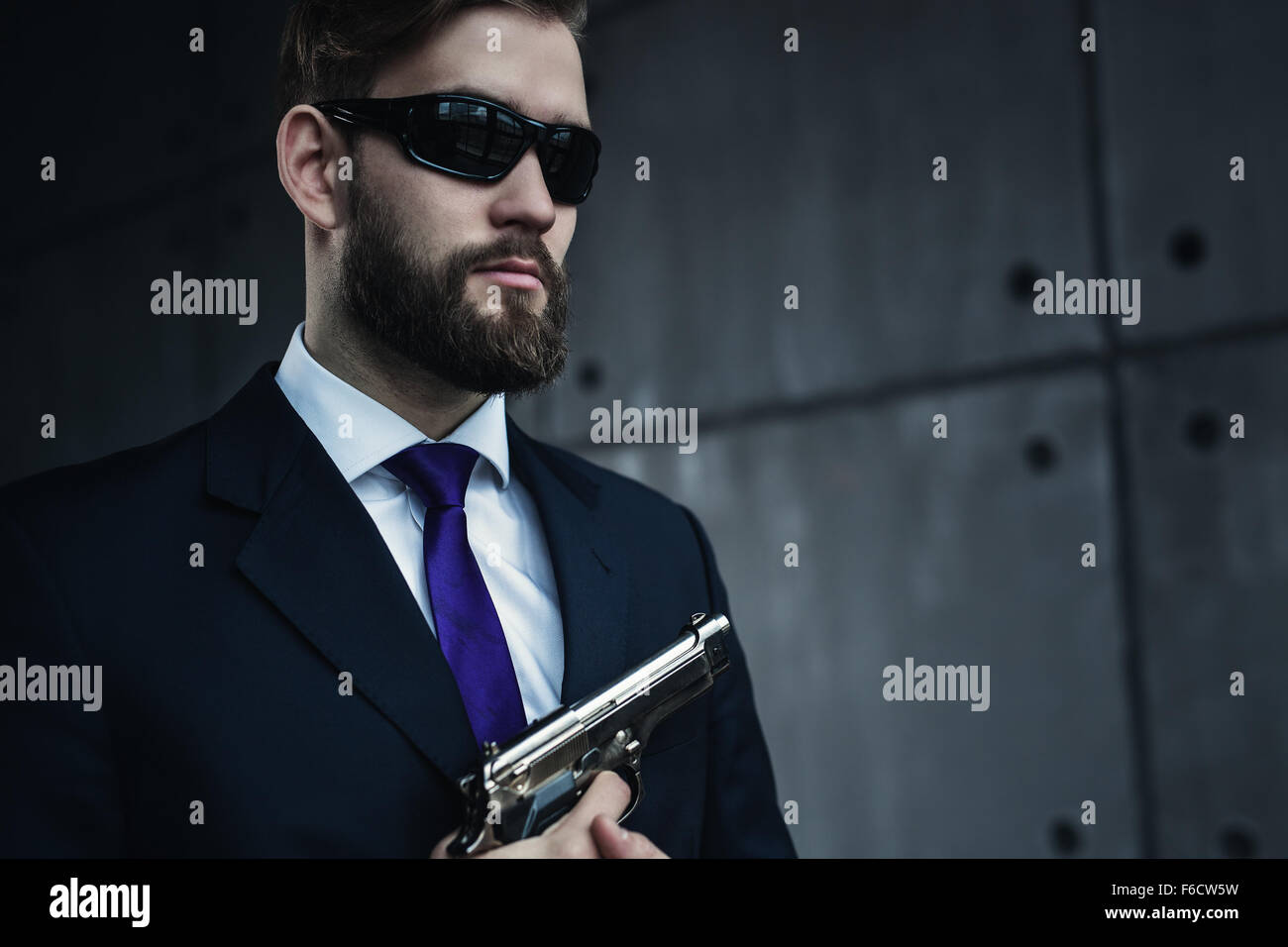 Danger man agent with gun and sunglasses portrait Stock Photo - Alamy