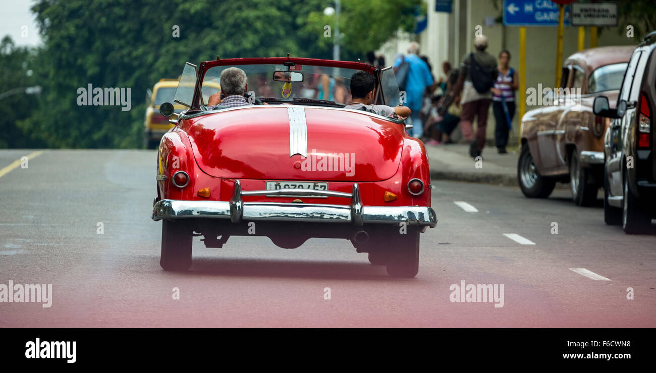 red vintage convertible in the streets, old American road cruiser on ...