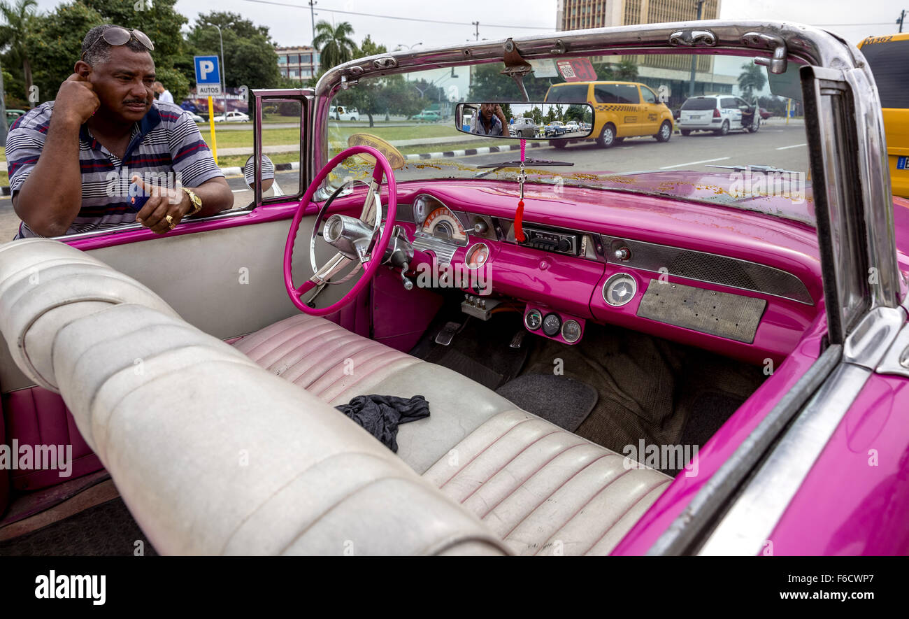 driver looking into his car, Taxidriver, pink convertible taxi ...