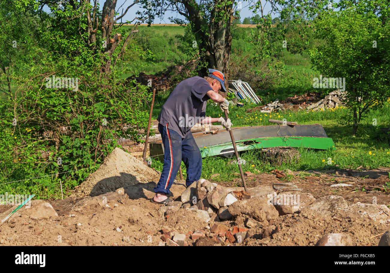 Construction of rural house foundation with use of natural boulders ...