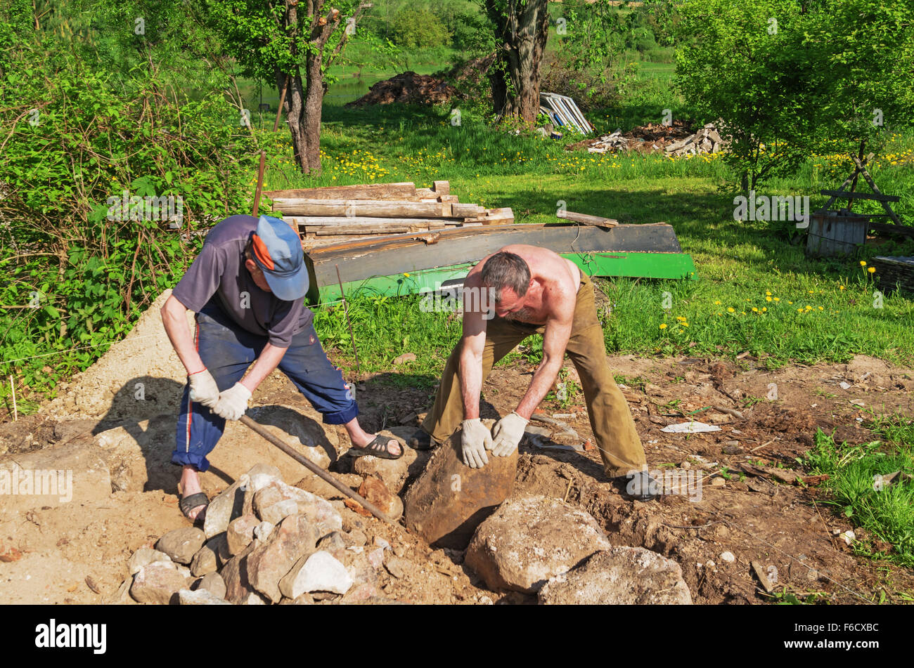 Construction of rural house foundation with use of natural boulders ...