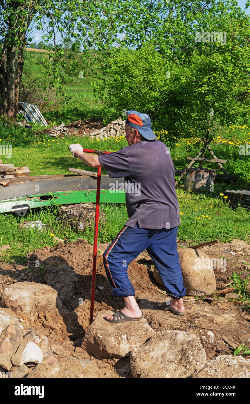 Construction of rural house foundation with use of natural boulders ...