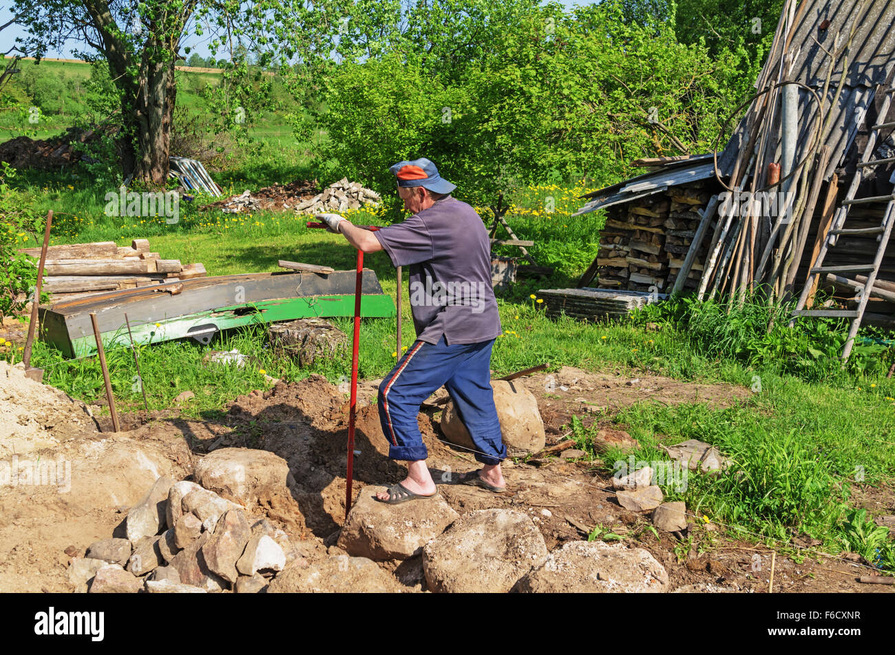 Construction of rural house foundation with use of natural boulders ...