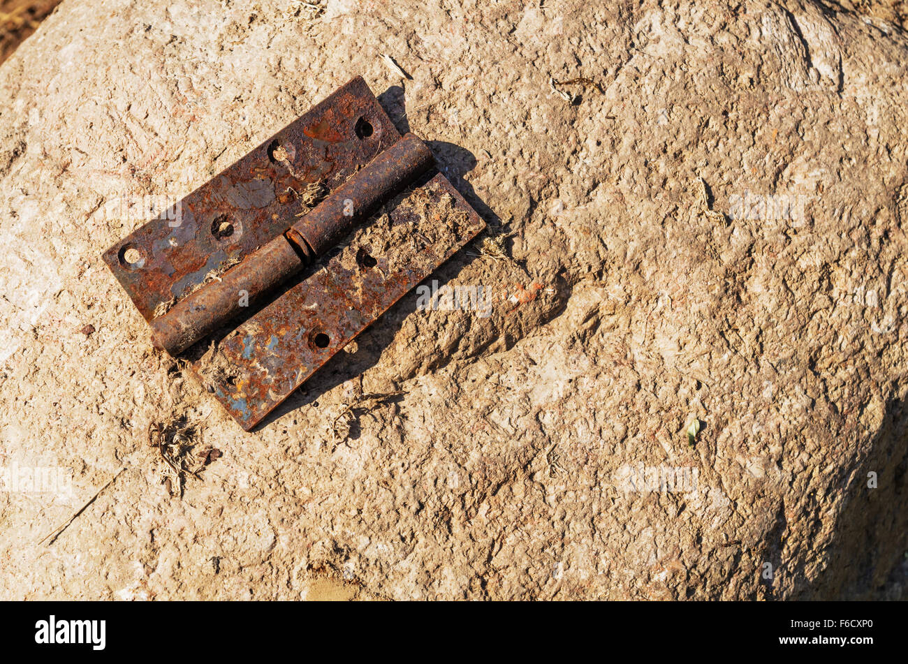 Old rusty hinge from a door on a stone Stock Photo - Alamy