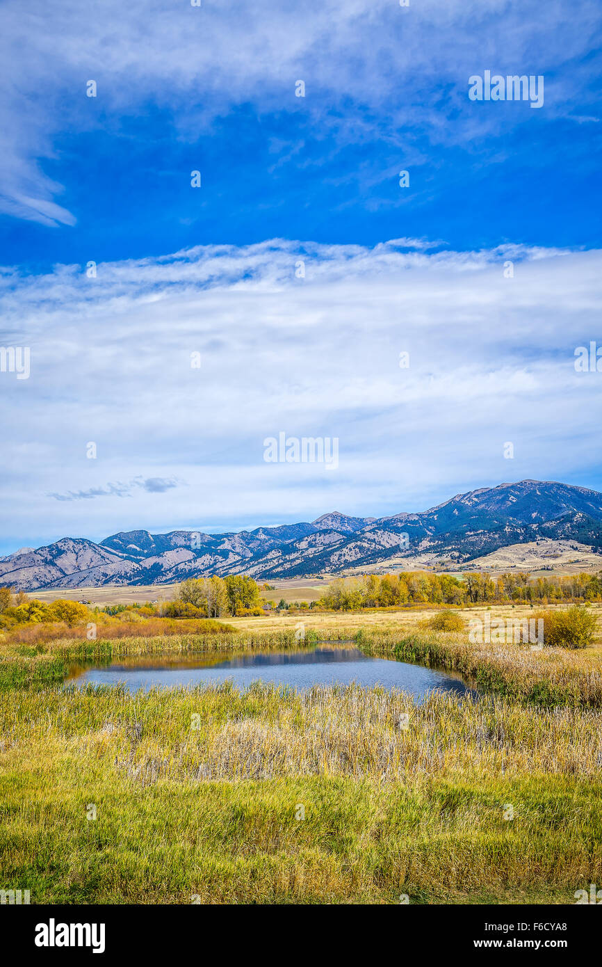 Pond in autumn fields at foot of Bridger mountain range in Cherry Creek ...
