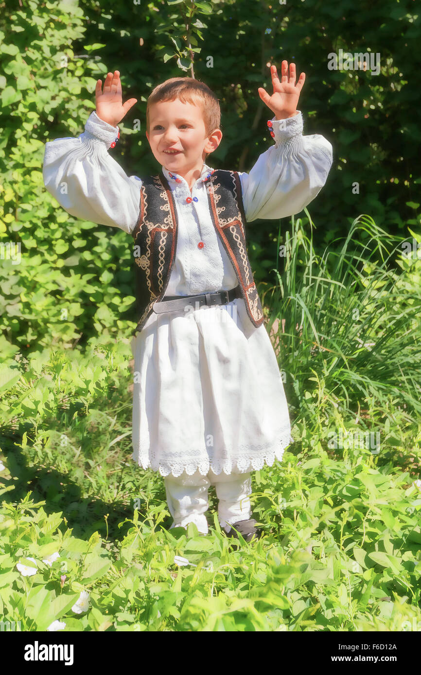 Romanian Peasant Child Dressed In A Traditional Costume Dancing A ...