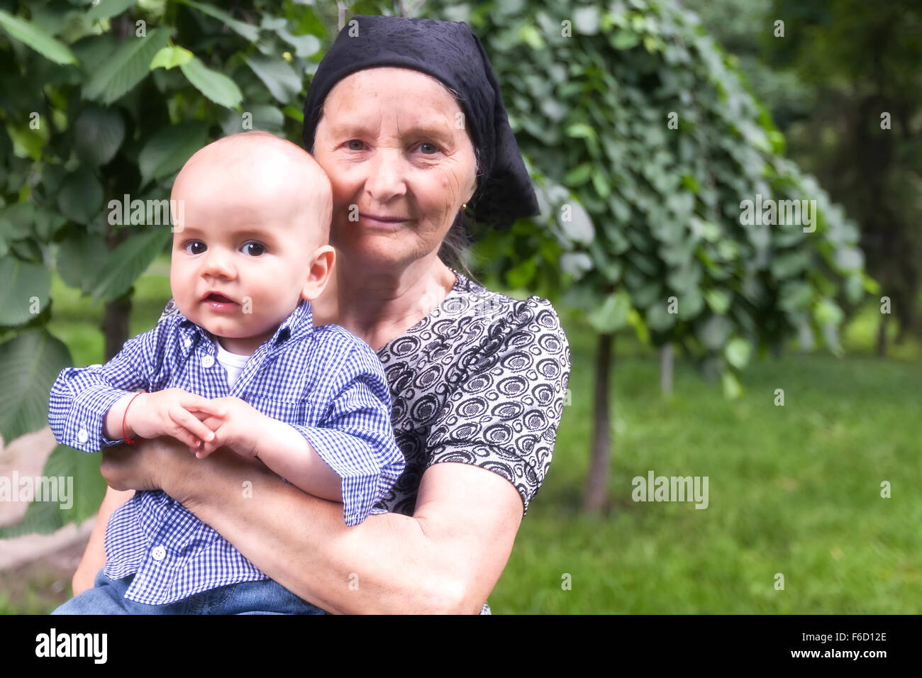 Happy Grandmother Clutching At Her Chest Her Eight Months Baby Grandson ...