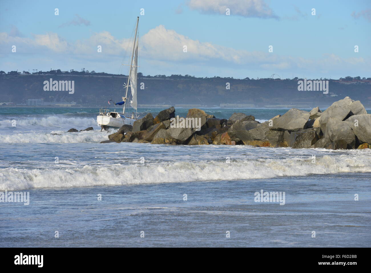 A Yacht being ship wrecked on the rocks on the beach at San Diego ...