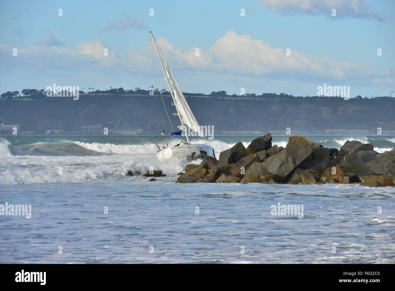 A Yacht being ship wrecked on the rocks on the beach at San Diego ...