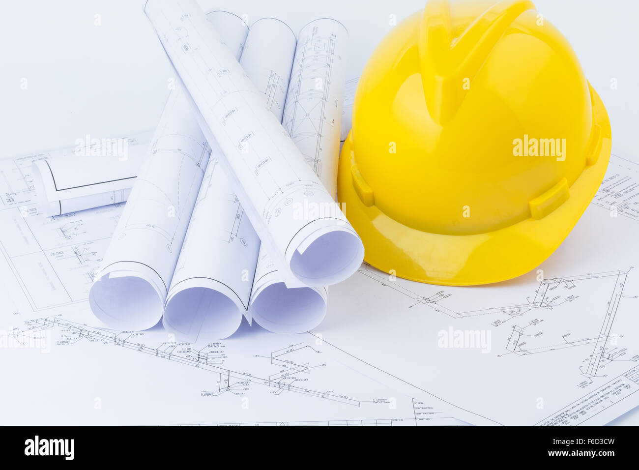 Yellow safety helmet and Scrolls of engineering drawings Stock Photo ...