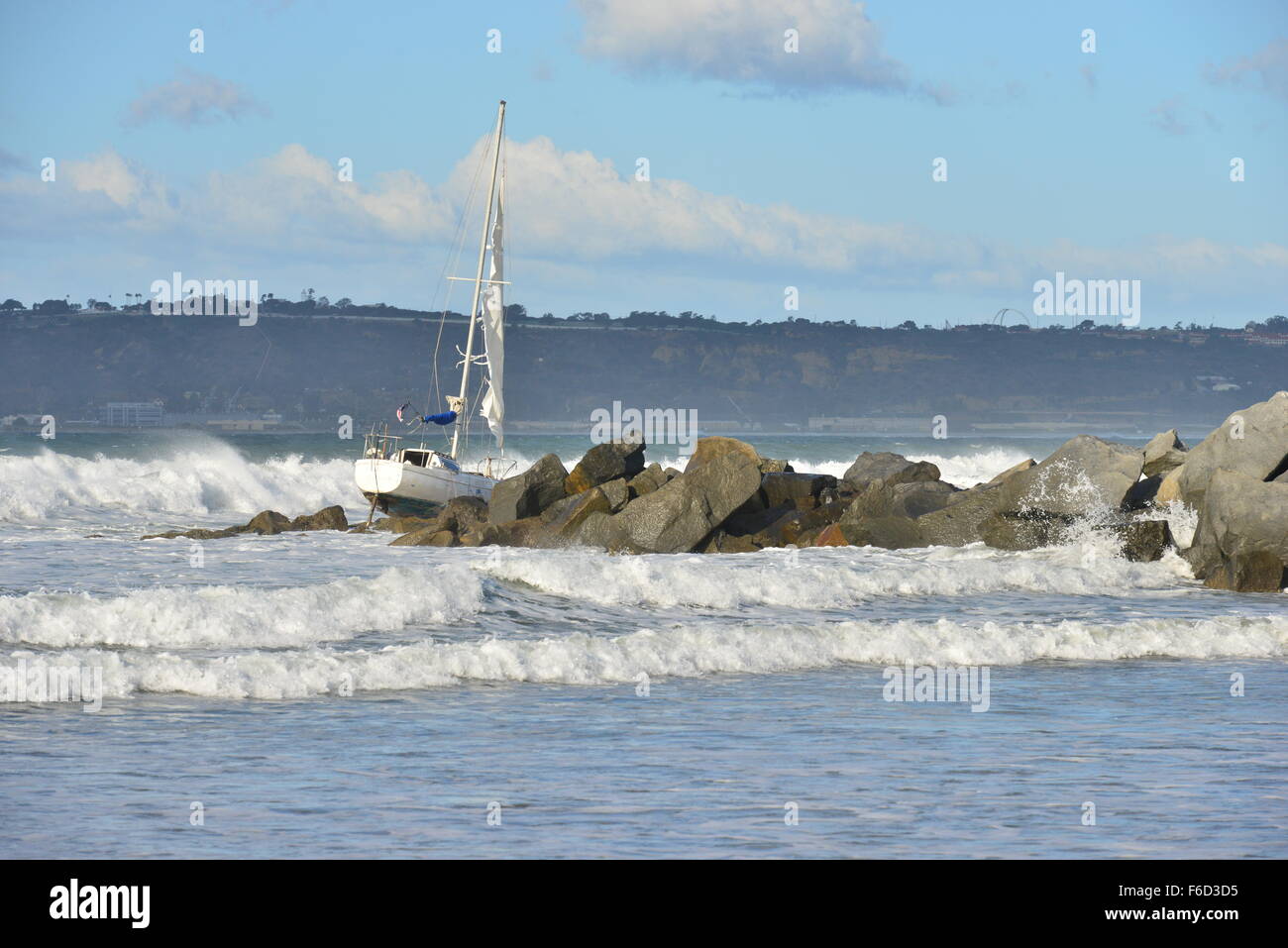 A Yacht being ship wrecked on the rocks on the beach at San Diego ...