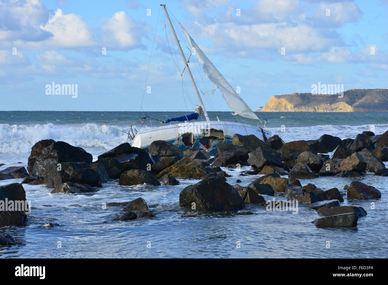 A Yacht being ship wrecked on the rocks on the beach at San Diego ...