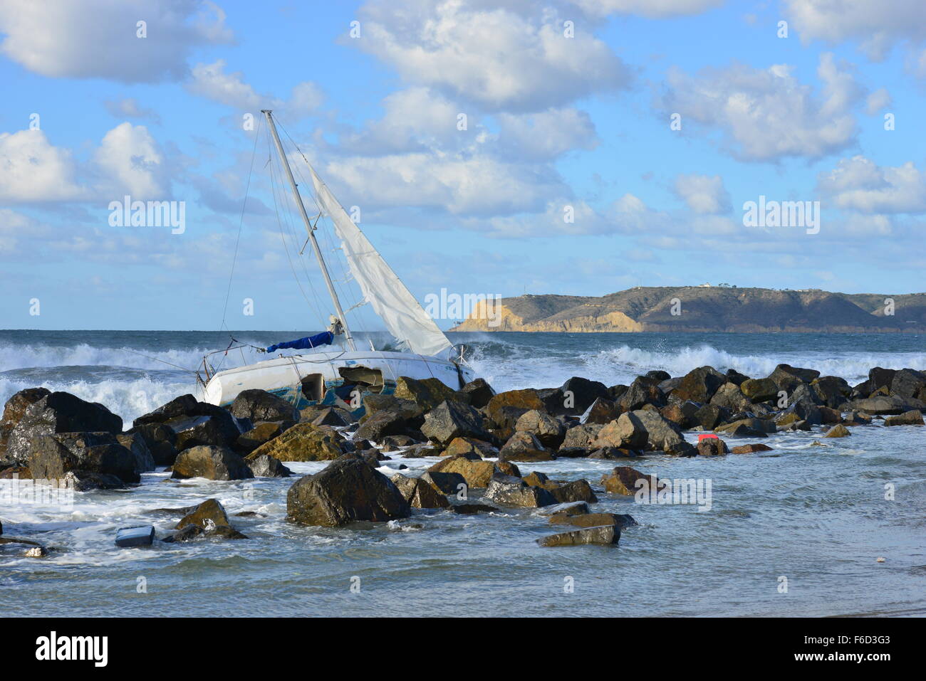 A Yacht being ship wrecked on the rocks on the beach at San Diego ...