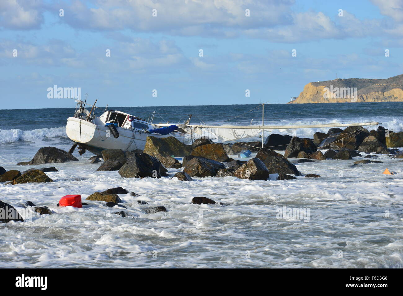 A Yacht being ship wrecked on the rocks on the beach at San Diego ...