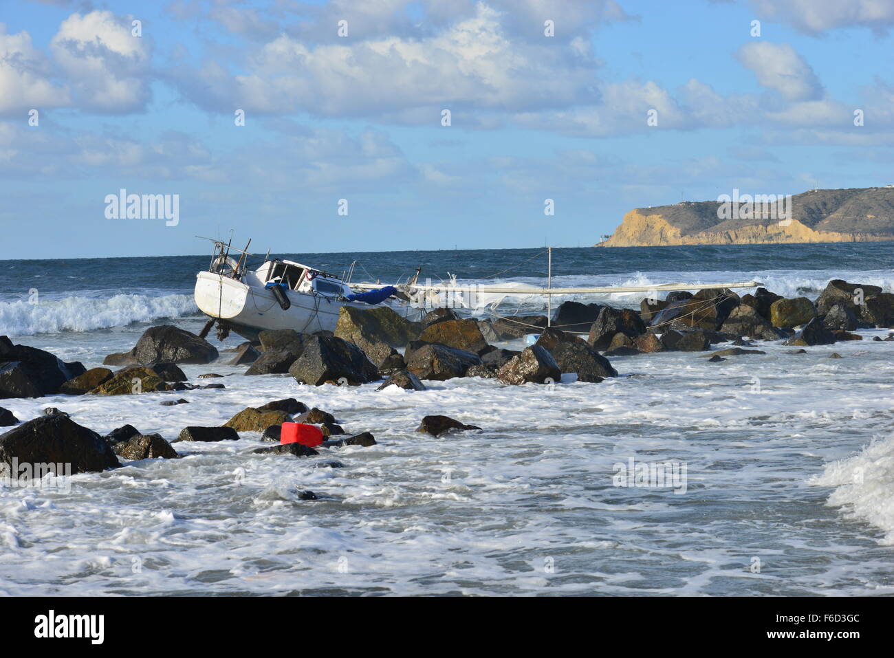 A Yacht being ship wrecked on the rocks on the beach at San Diego ...