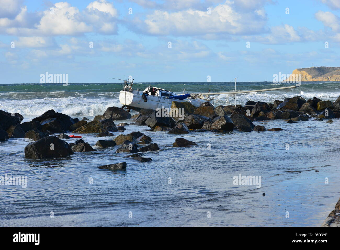 A Yacht being ship wrecked on the rocks on the beach at San Diego ...