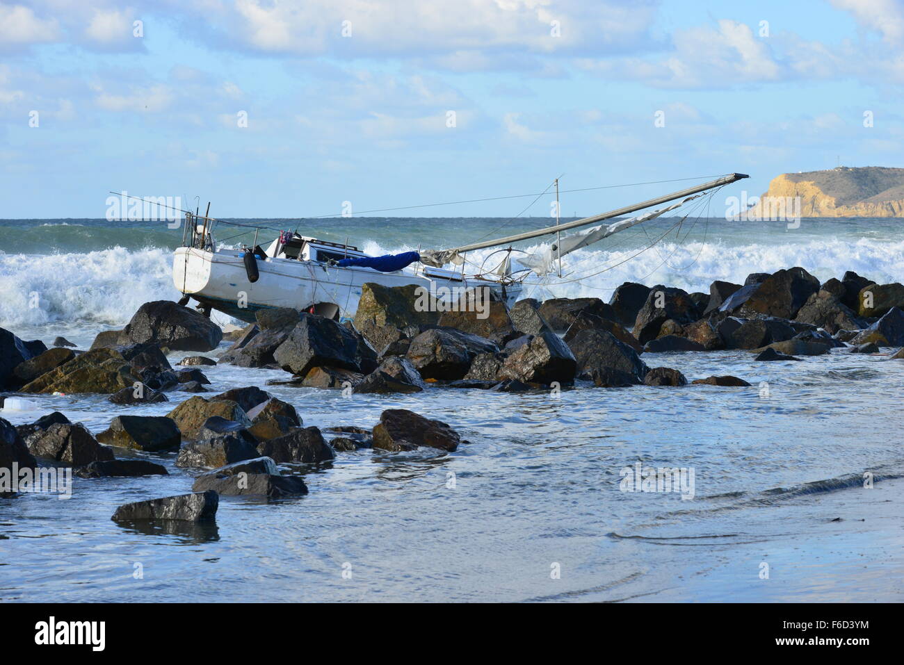 A Yacht being ship wrecked on the rocks on the beach at San Diego ...