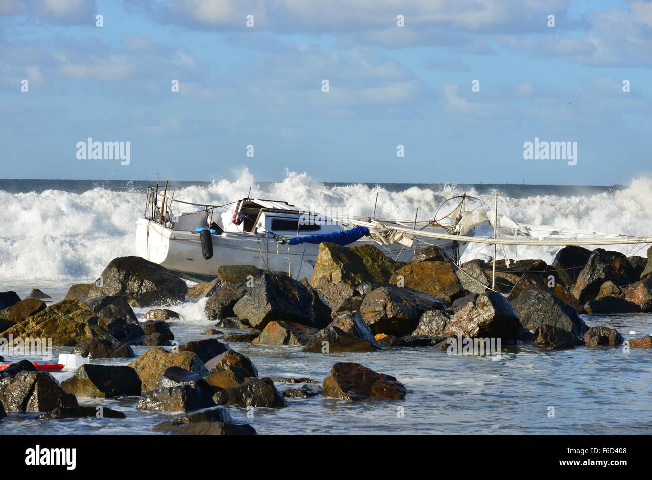 A Yacht being ship wrecked on the rocks on the beach at San Diego ...
