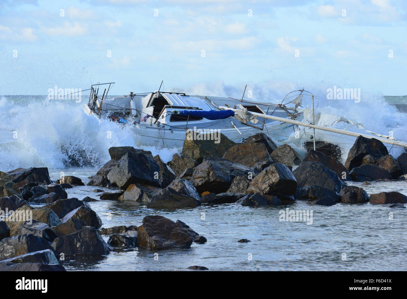 A Yacht being ship wrecked on the rocks on the beach at San Diego ...