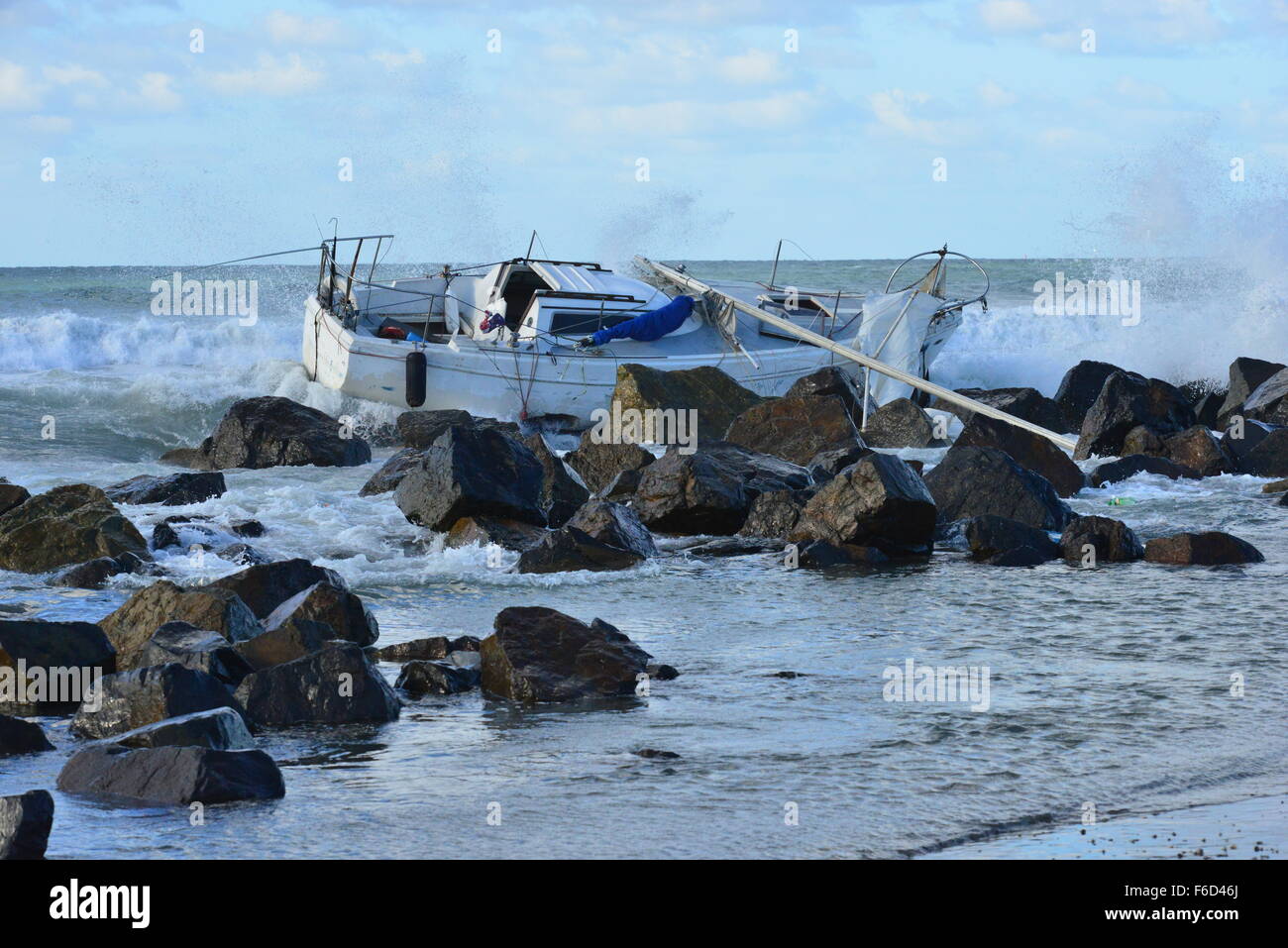 A Yacht being ship wrecked on the rocks on the beach at San Diego ...