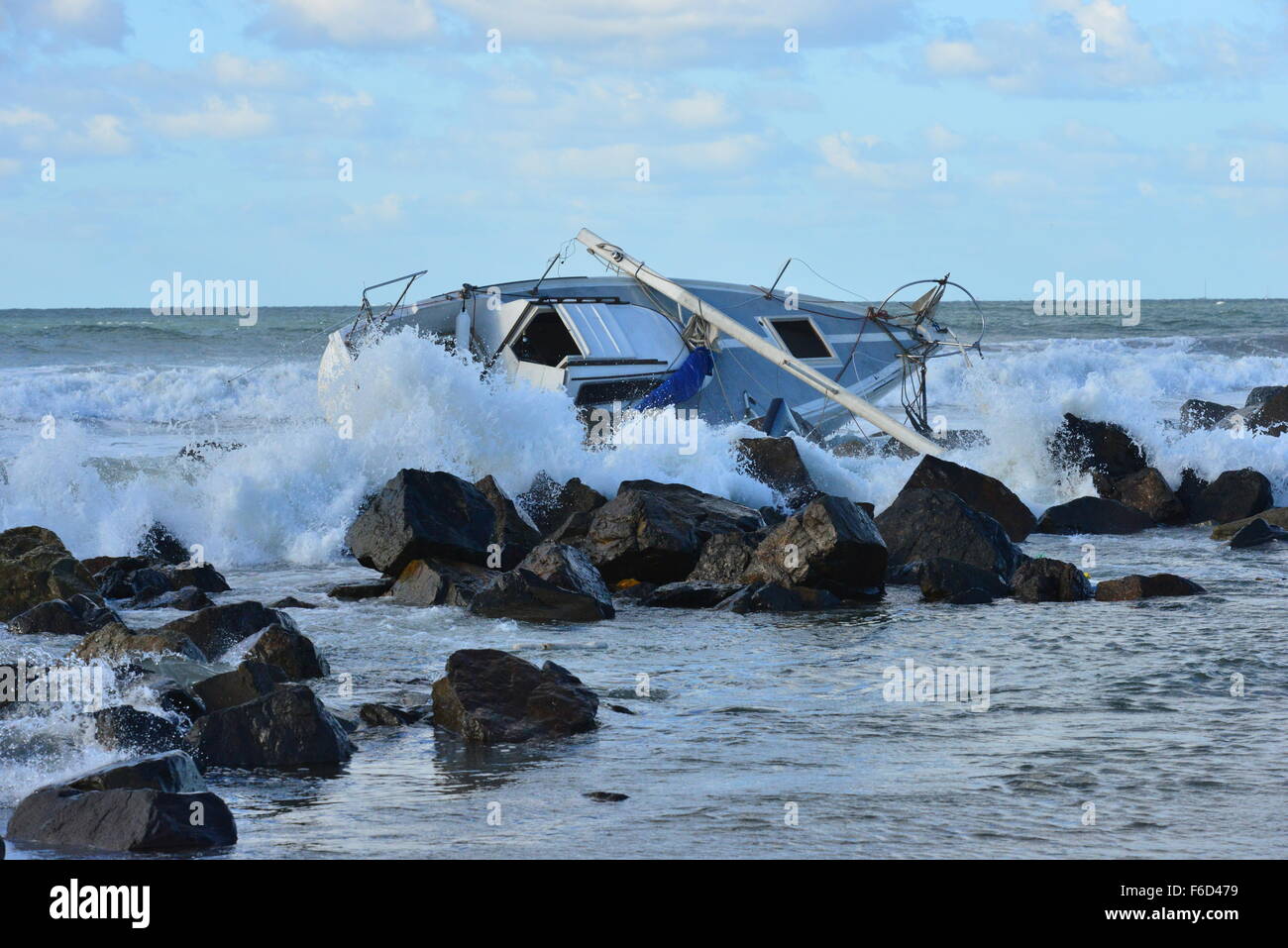 A Yacht being ship wrecked on the rocks on the beach at San Diego ...