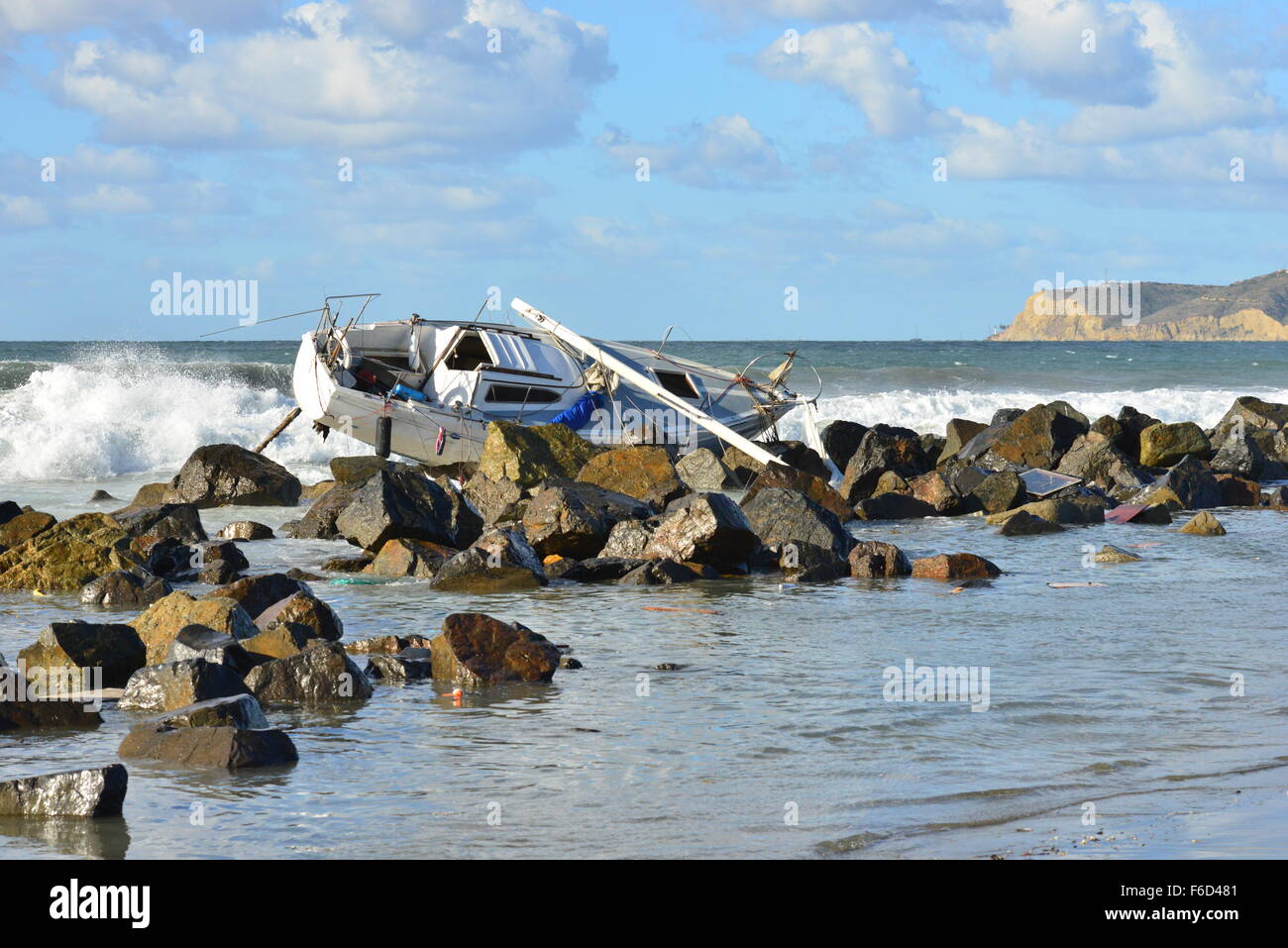 A Yacht being ship wrecked on the rocks on the beach at San Diego ...