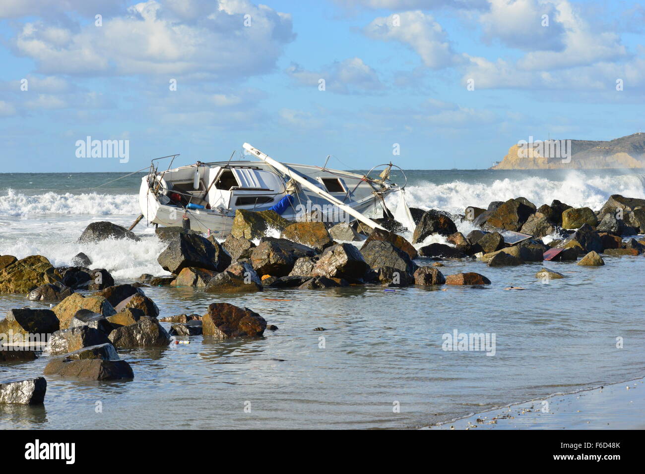 A Yacht being ship wrecked on the rocks on the beach at San Diego ...