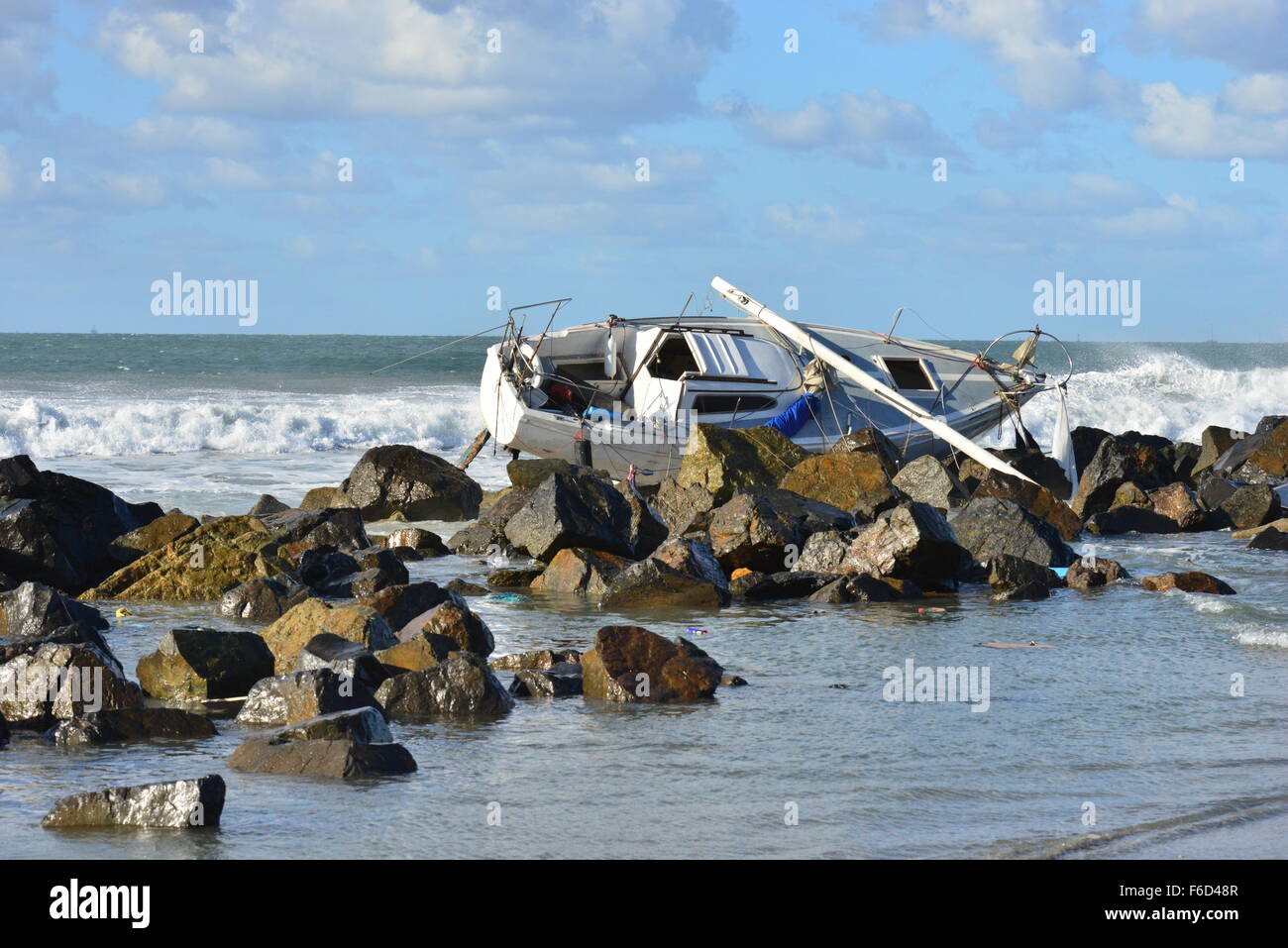 A Yacht being ship wrecked on the rocks on the beach at San Diego ...