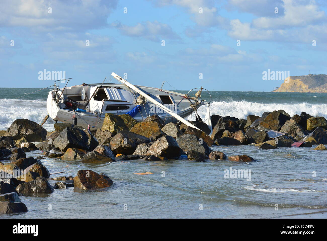 A Yacht being ship wrecked on the rocks on the beach at San Diego ...